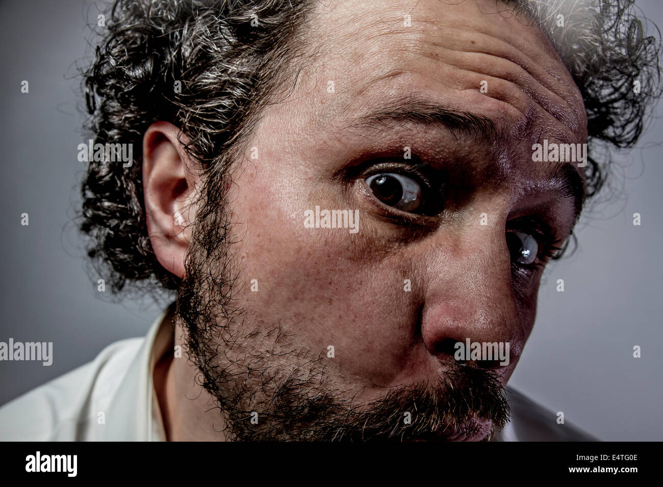 Fear, man with intense expression, white shirt Stock Photo - Alamy