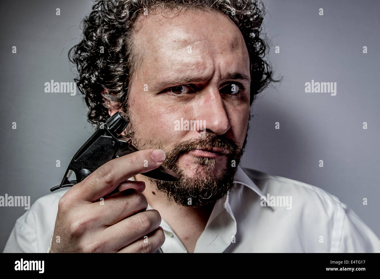 cleaning spray, man with intense expression, white shirt Stock Photo ...