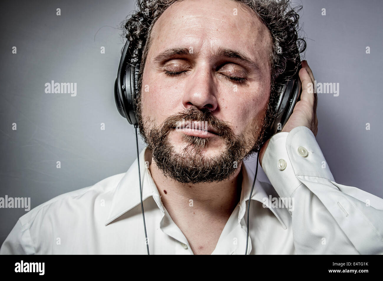 enjoy the music, man with intense expression, white shirt Stock Photo ...