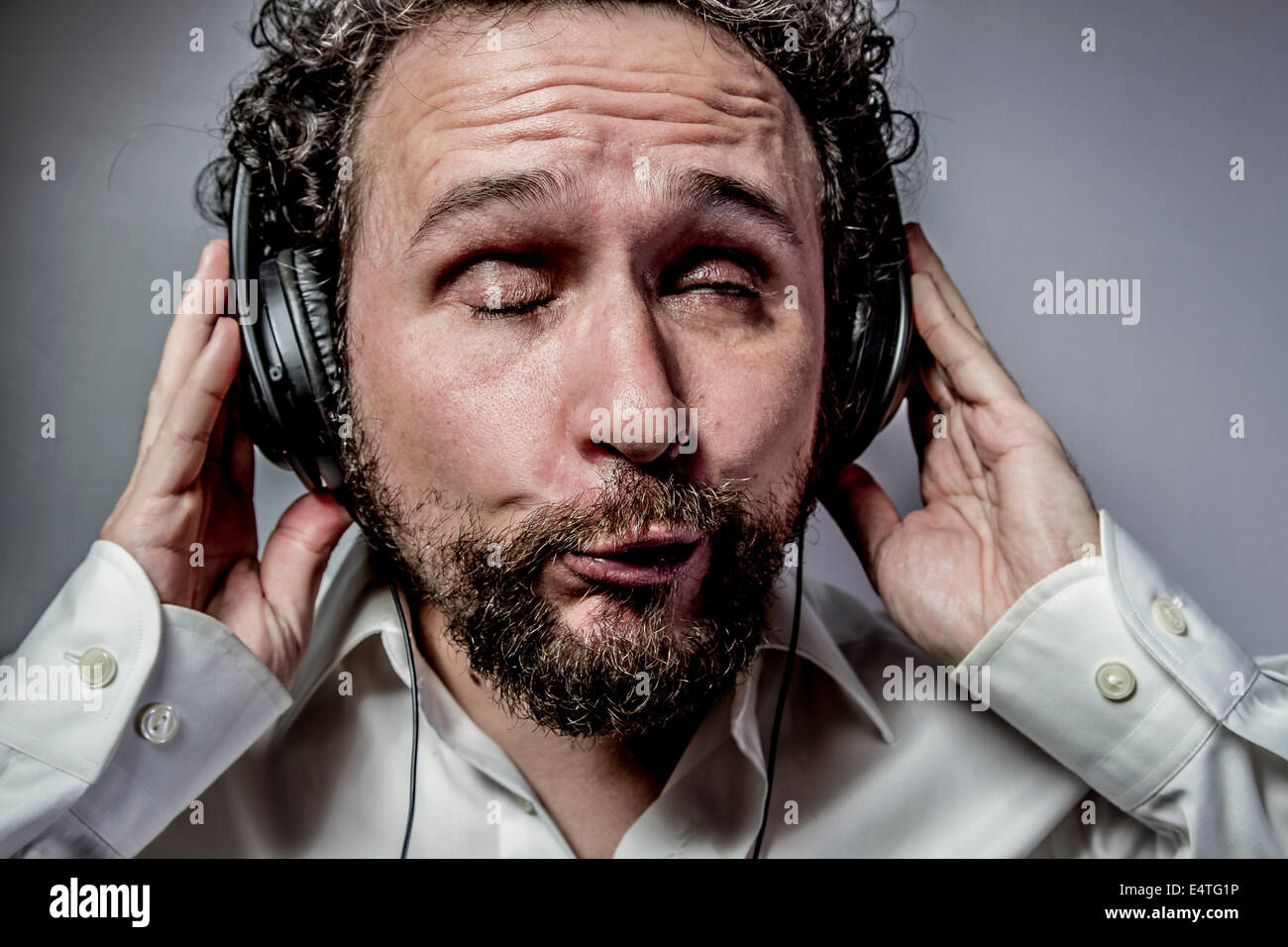 enjoy the music, man with intense expression, white shirt Stock Photo ...