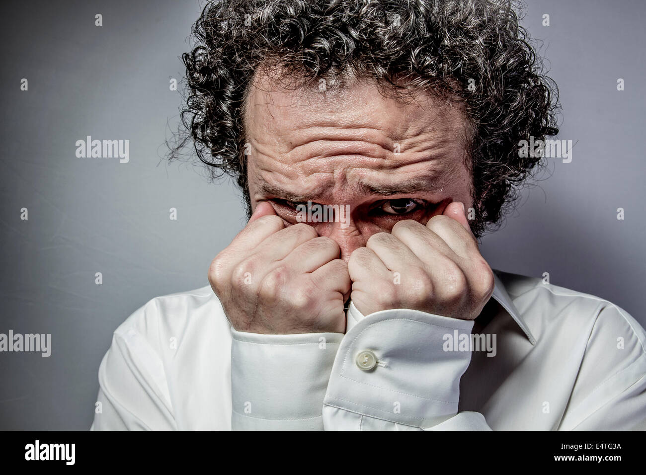 Fear, man with intense expression, white shirt Stock Photo - Alamy