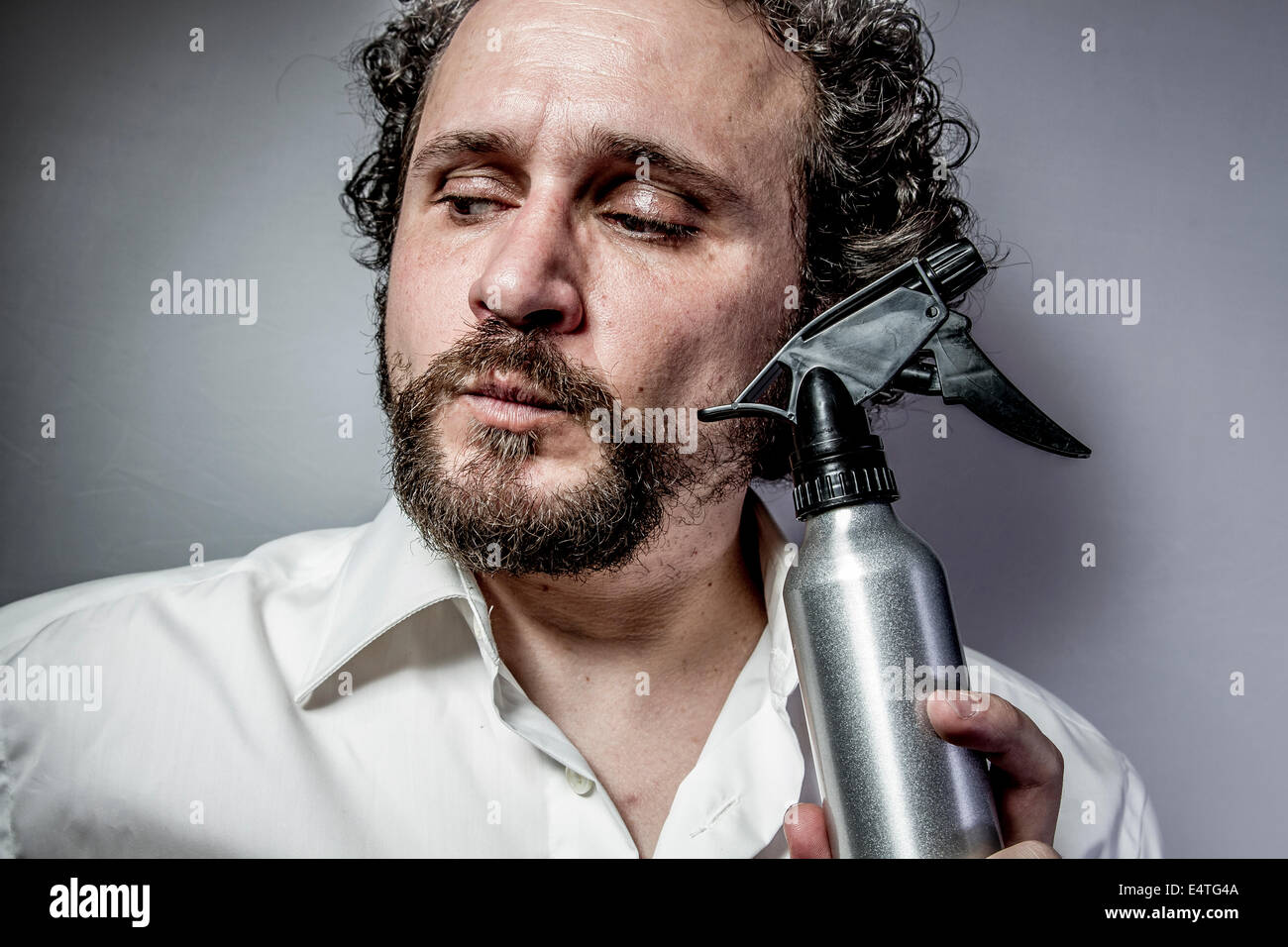 cleaning spray, man with intense expression, white shirt Stock Photo ...