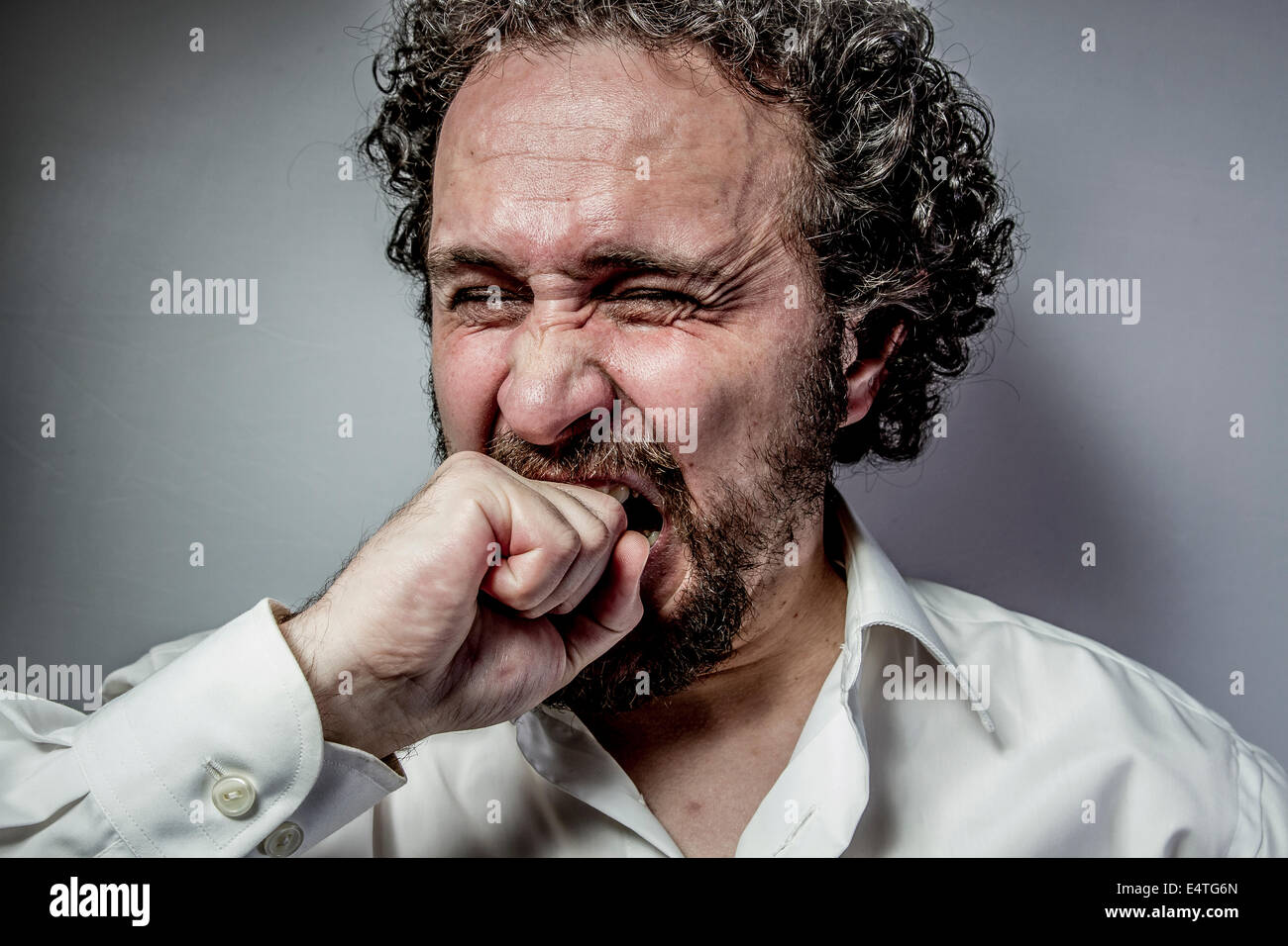 derision, man with intense expression, white shirt Stock Photo - Alamy