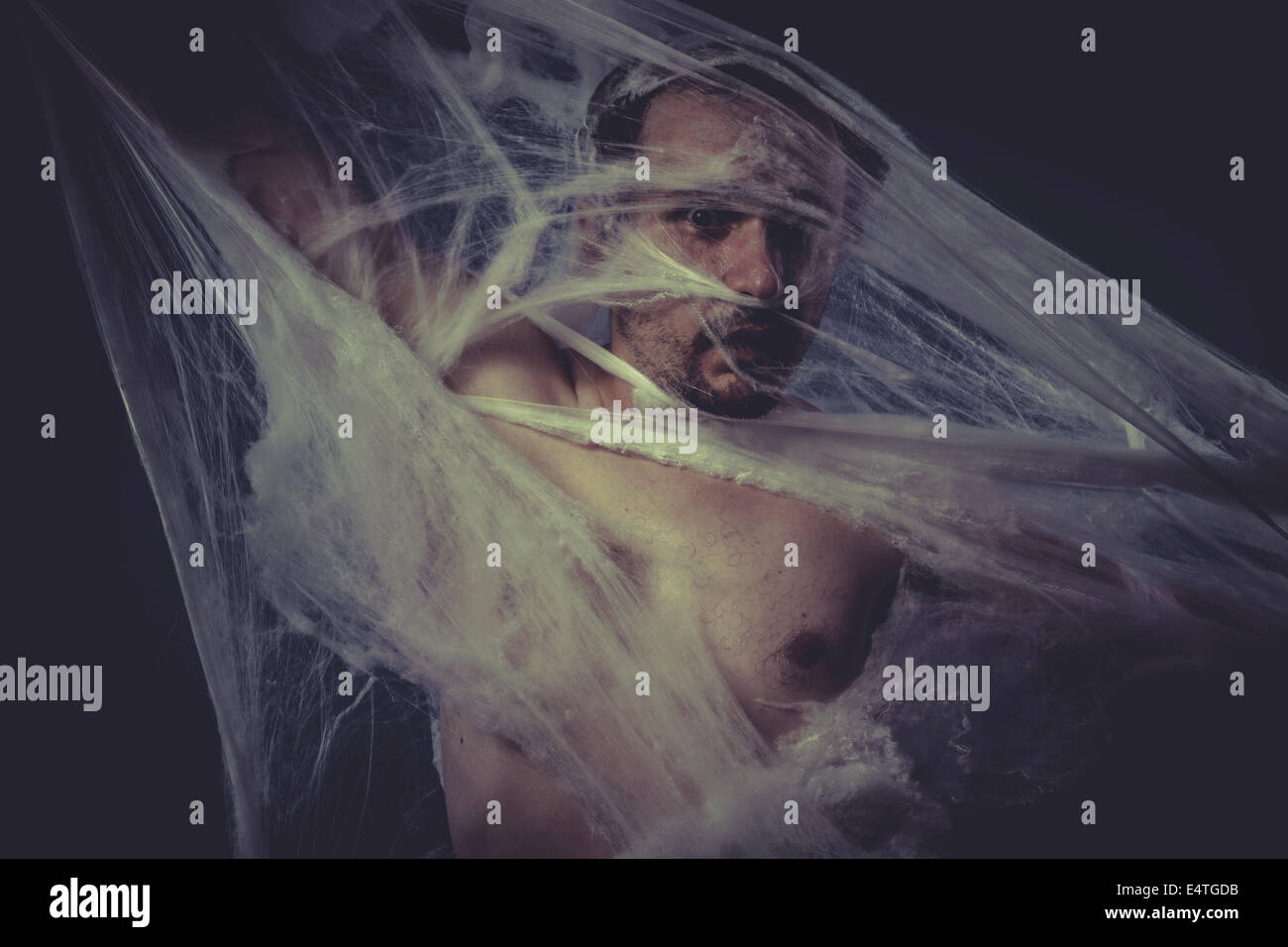 Depression, Man trapped in a spider web Stock Photo - Alamy