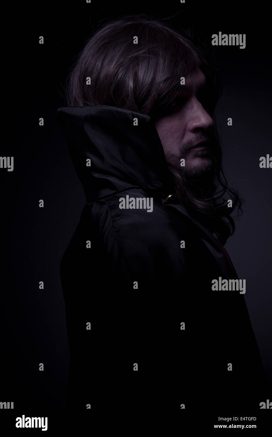 Goth, man with long hair and black coat Stock Photo - Alamy