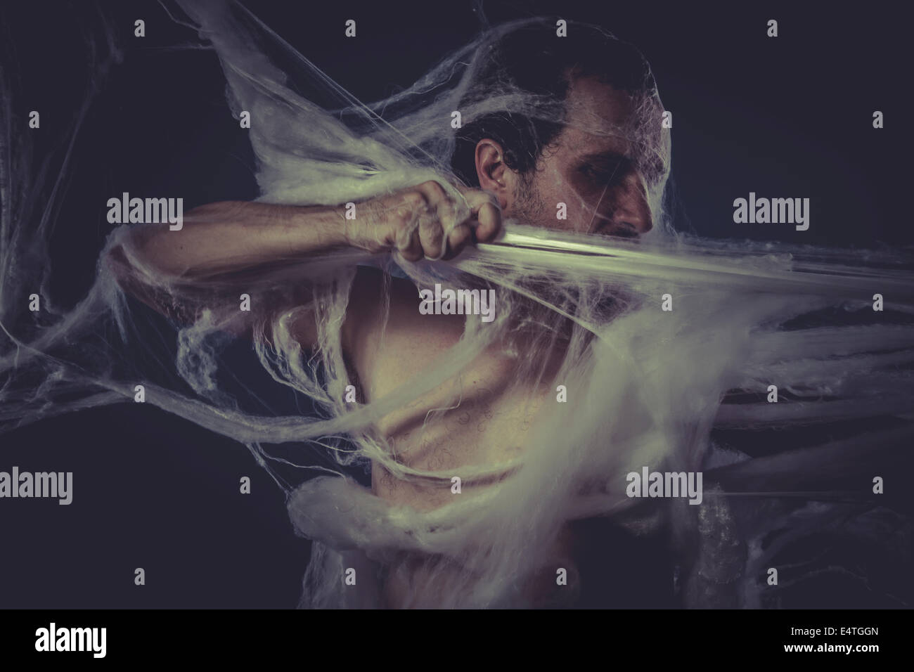 Horror, Man trapped in a spider web Stock Photo - Alamy