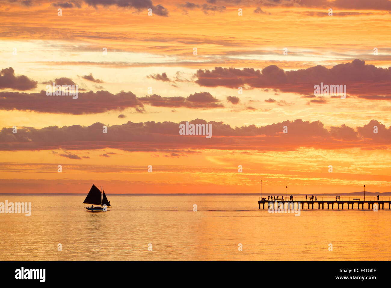 Boat sailing while sunset, beach Stock Photo - Alamy