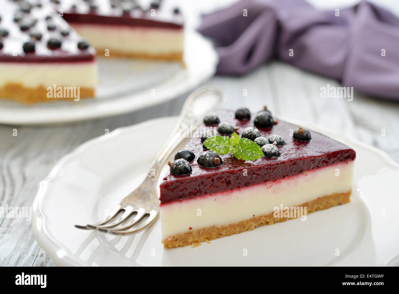 Black currant cheesecake with fresh berries on plate closeup Stock ...