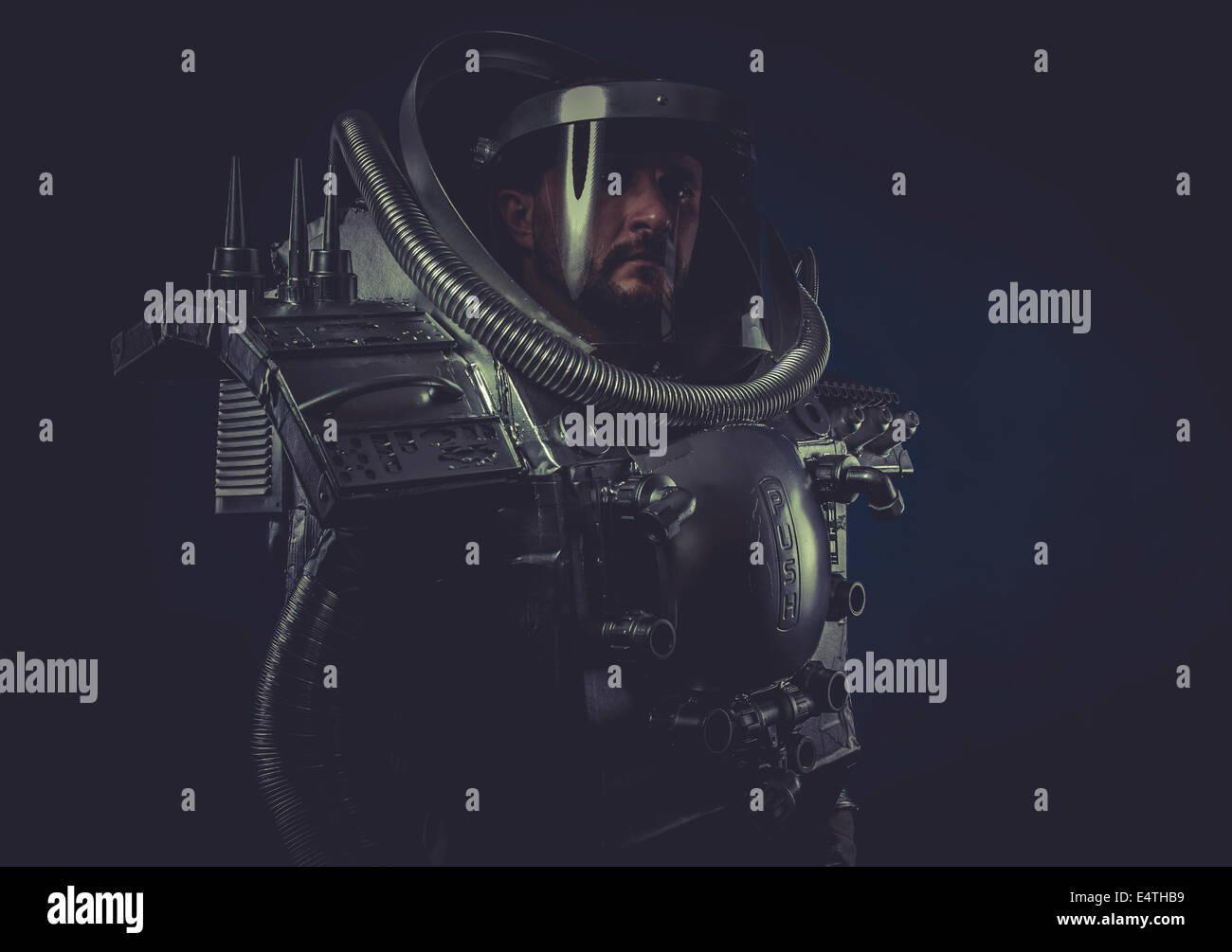 Serious, robot man in space armor silver Stock Photo - Alamy