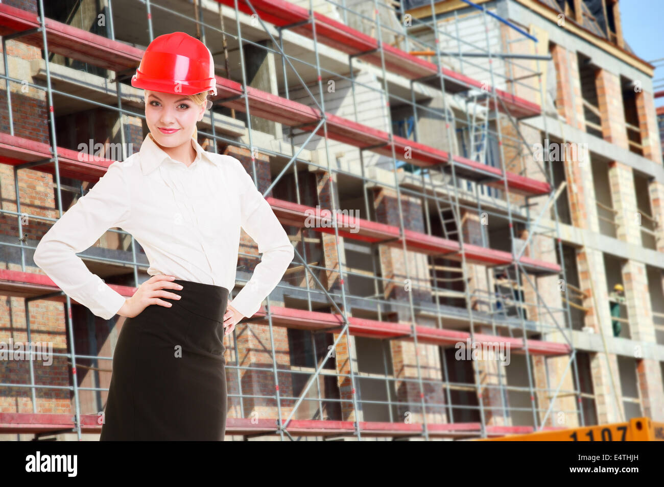 Female engineer woman architect in red safety helmet Stock Photo - Alamy