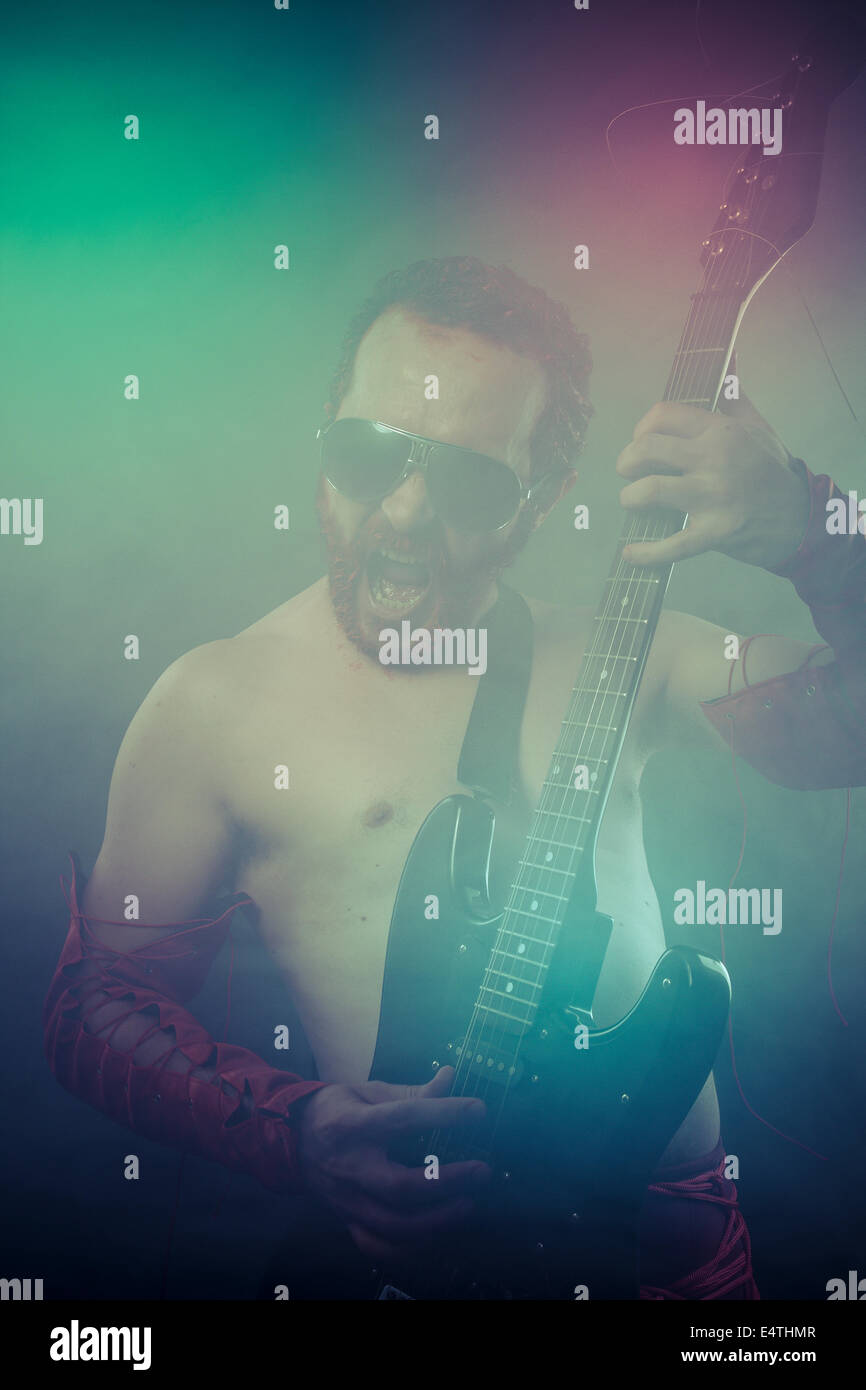 rocker man with electric guitar in a rock concert Stock Photo - Alamy