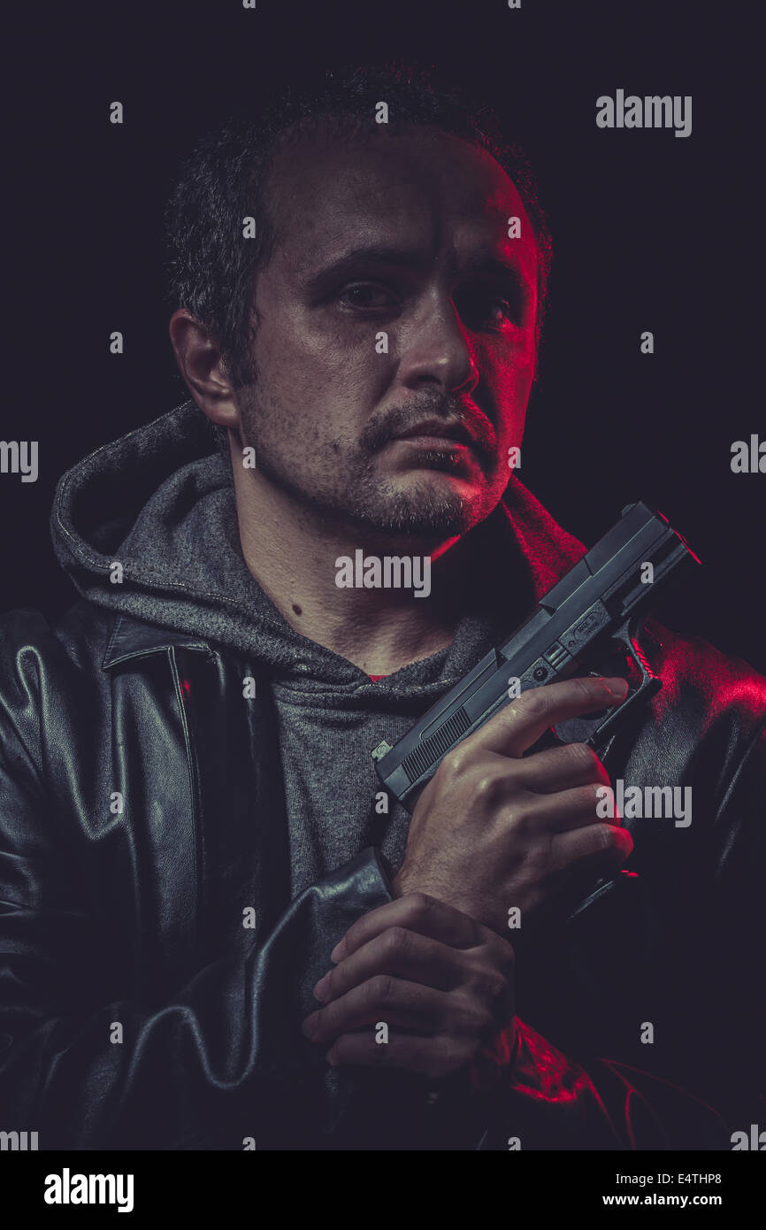 Danger, Assassin, man with black coat and gun Stock Photo - Alamy