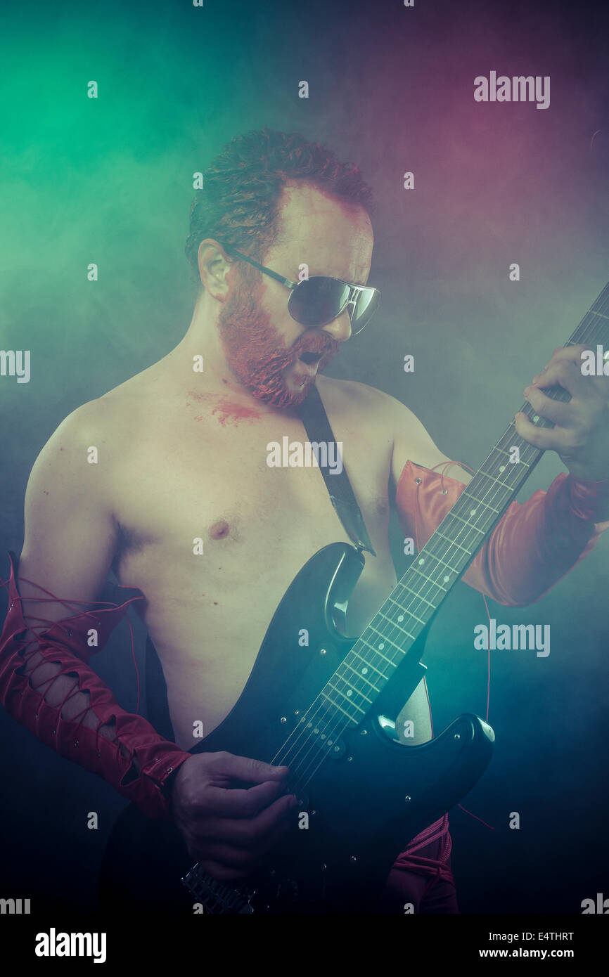 Heavy, rocker man with electric guitar in a rock concert Stock Photo ...