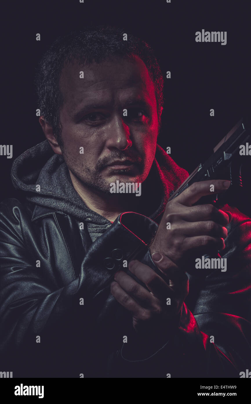 Agent, Assassin, man with black coat and gun Stock Photo - Alamy