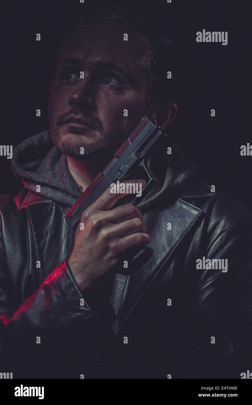 Killer, Assassin, man with black coat and gun Stock Photo - Alamy