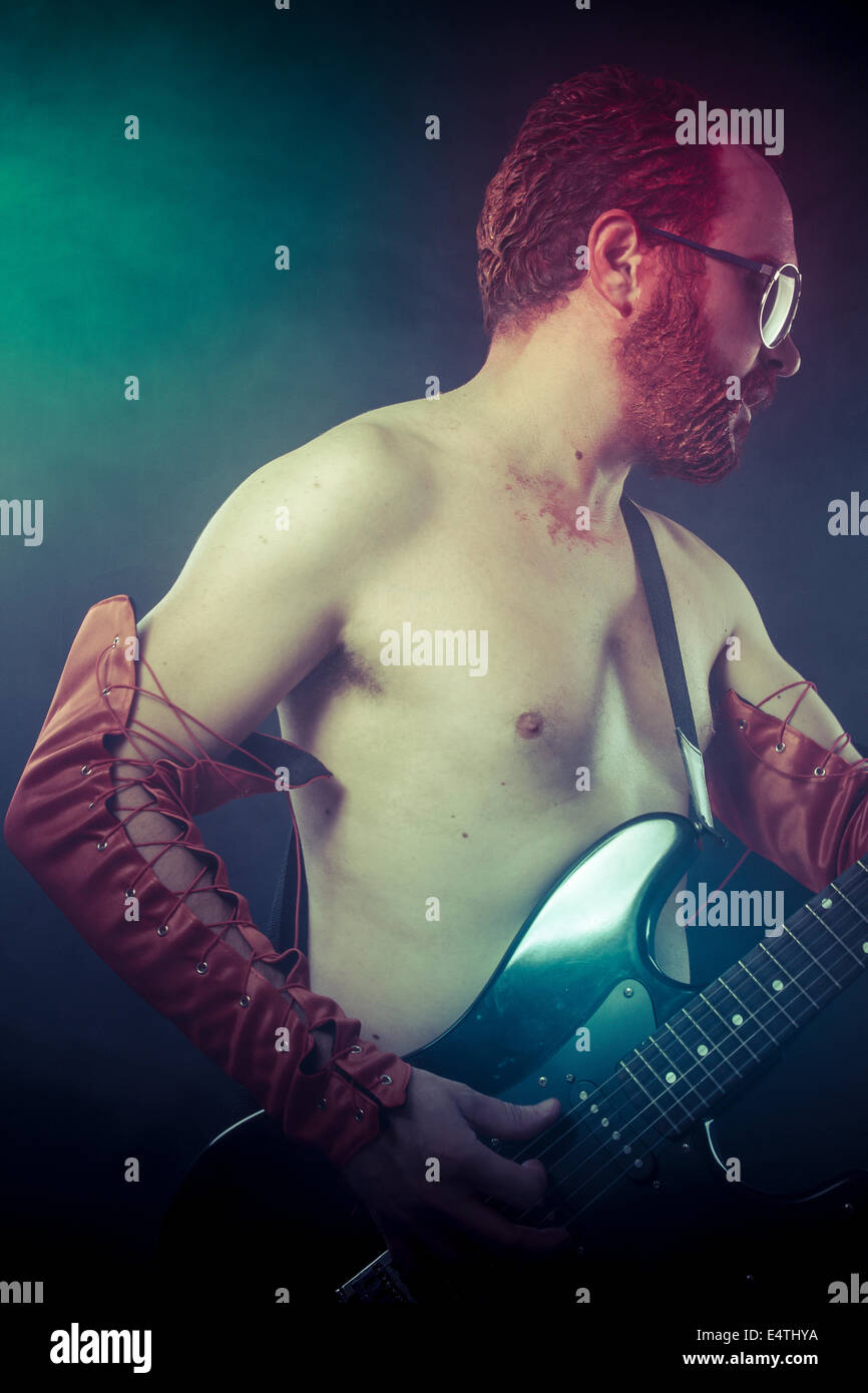 Metal, rocker man with electric guitar in a rock concert Stock Photo ...