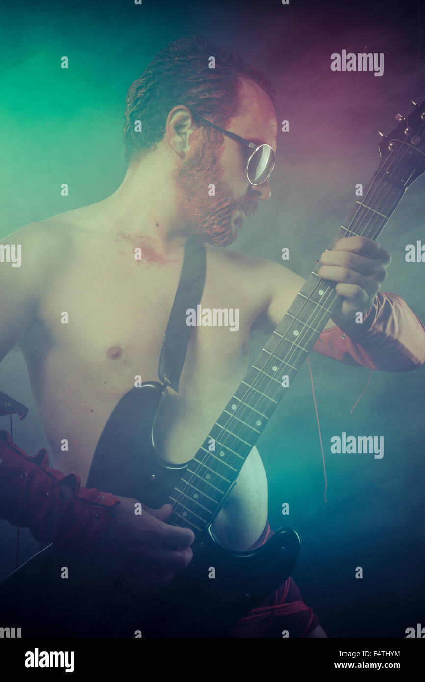 Metal, rocker man with electric guitar in a rock concert Stock Photo ...