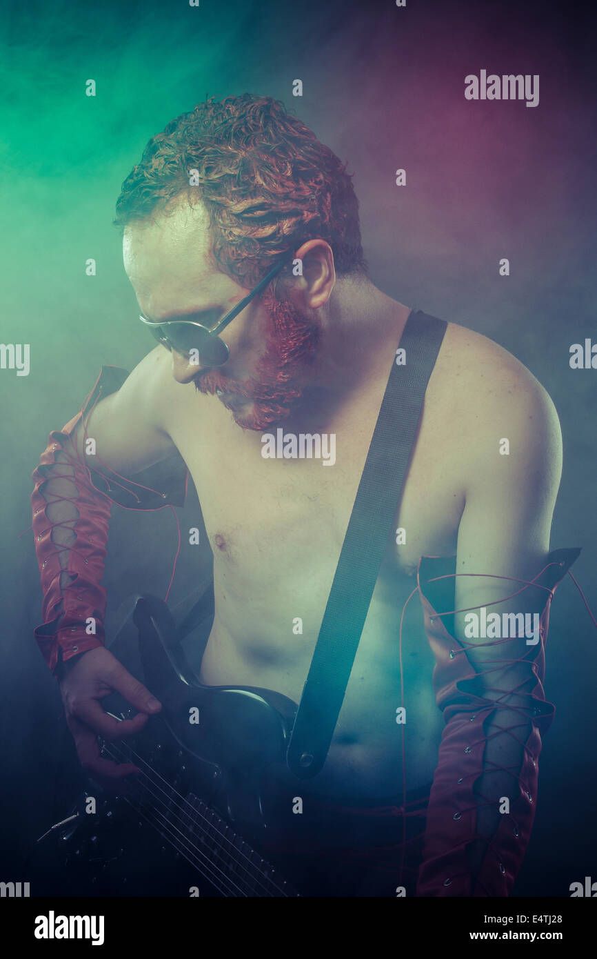 Play, rocker man with electric guitar in a rock concert Stock Photo - Alamy
