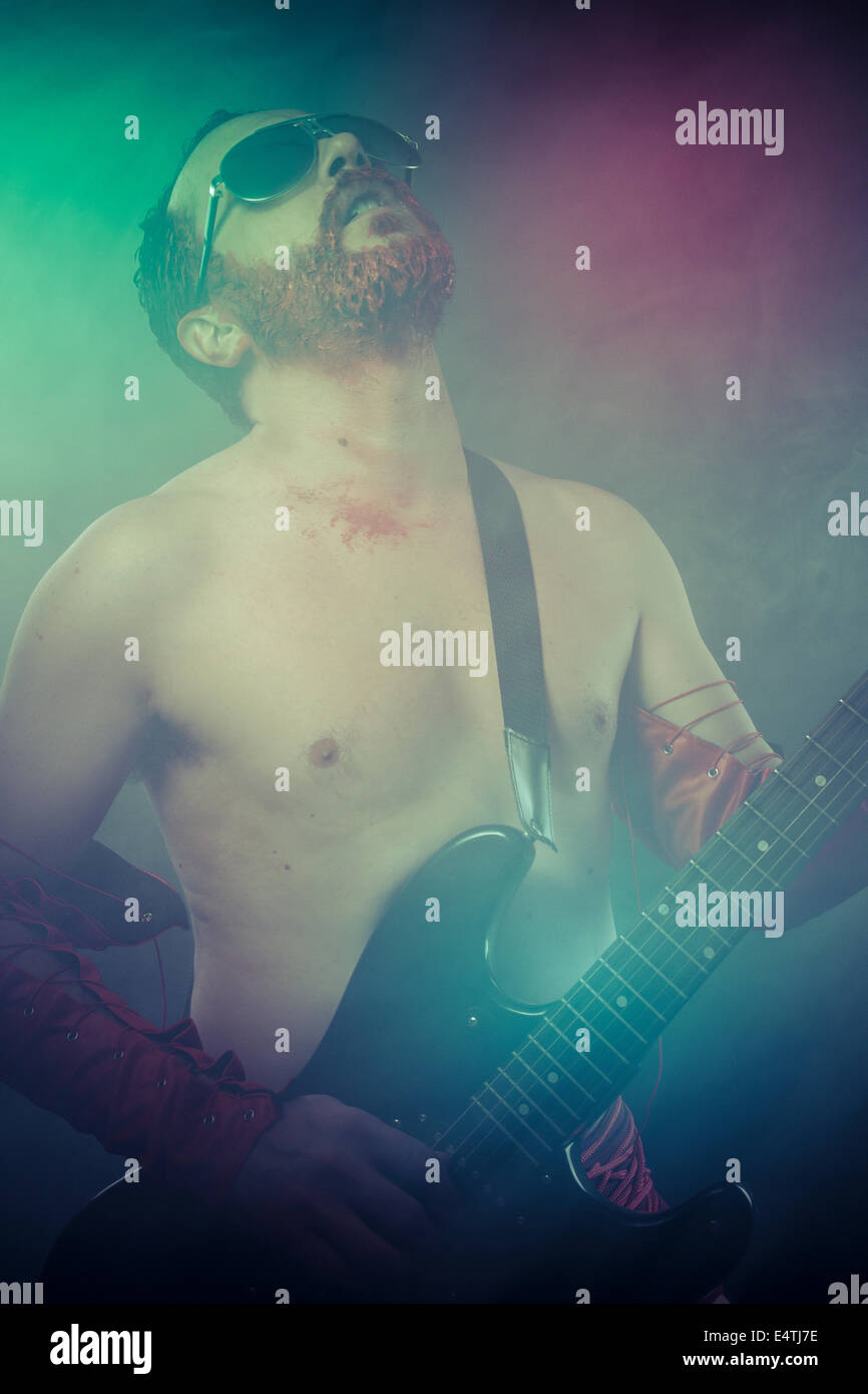 rocker man with electric guitar in a rock concert Stock Photo - Alamy