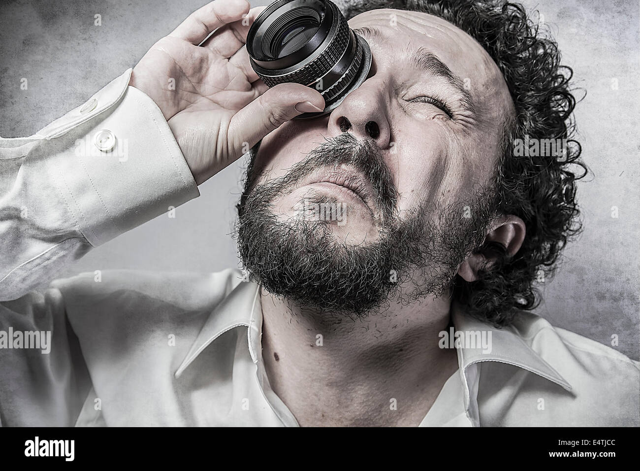 Businessman looking through a lens, man in white shirt with funny ...