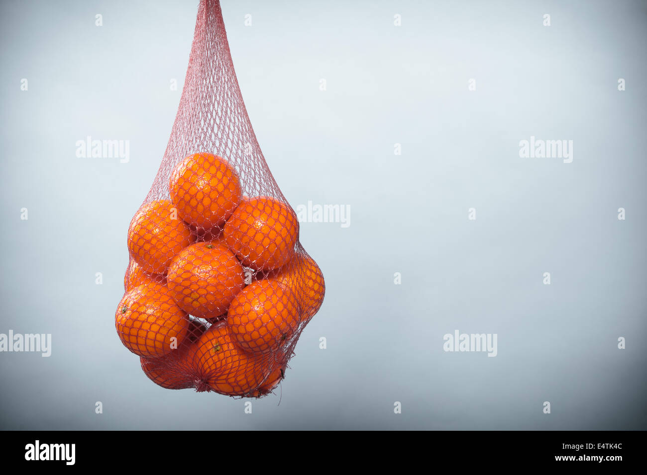 Mesh bag of fresh oranges healthy tropical fruits from supermarket on ...
