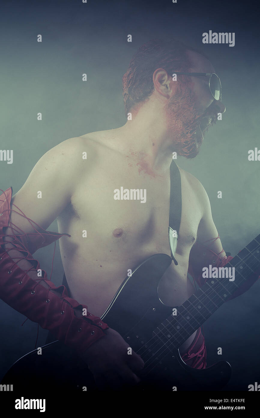 Heavy, rocker man with electric guitar in a rock concert Stock Photo ...