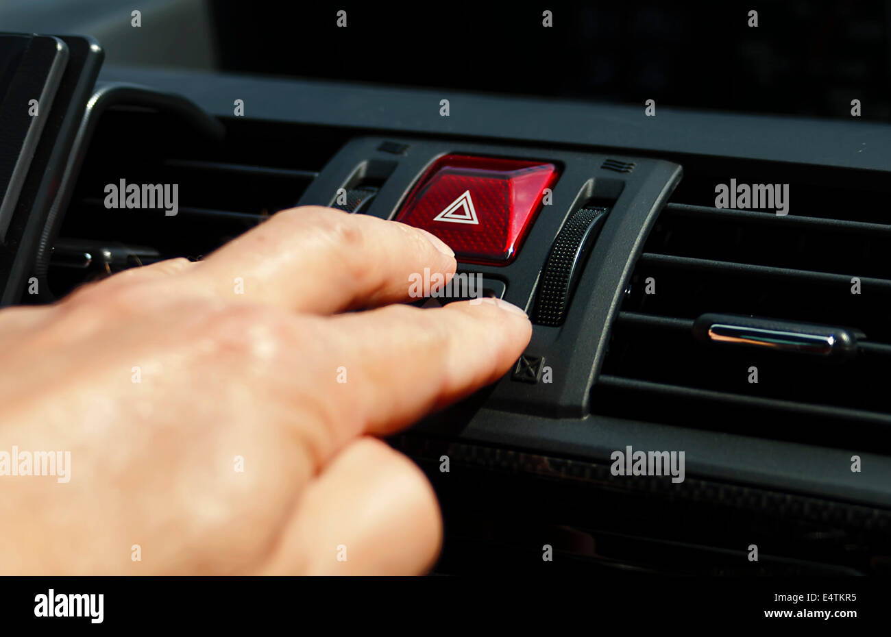 Hand pressing a hazard button, concept of safety on the roads Stock ...