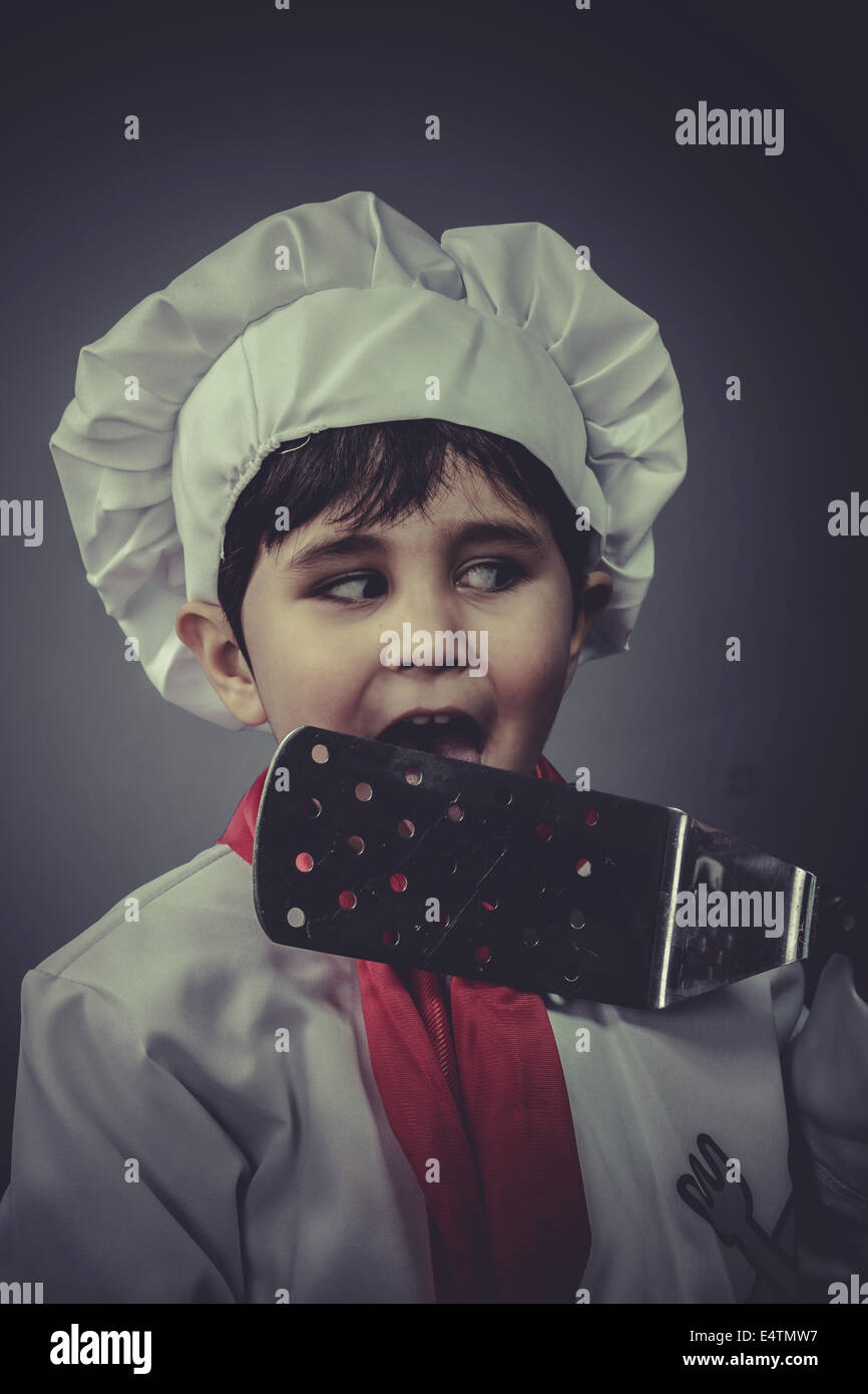 boy dressed as a cook with kitchen utensils Stock Photo - Alamy