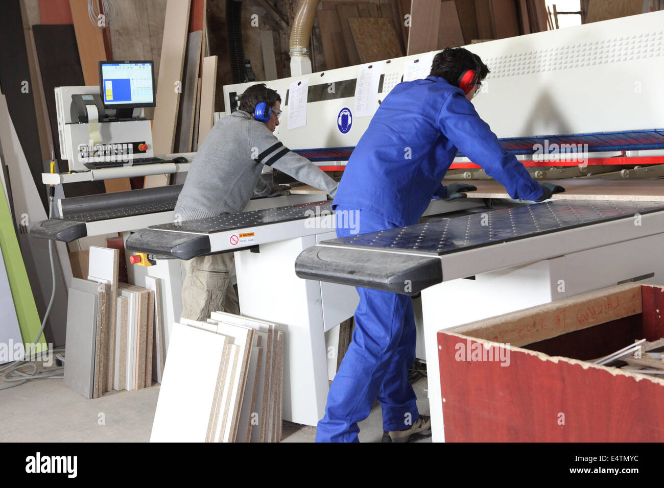 Two men using factory equipment Stock Photo - Alamy