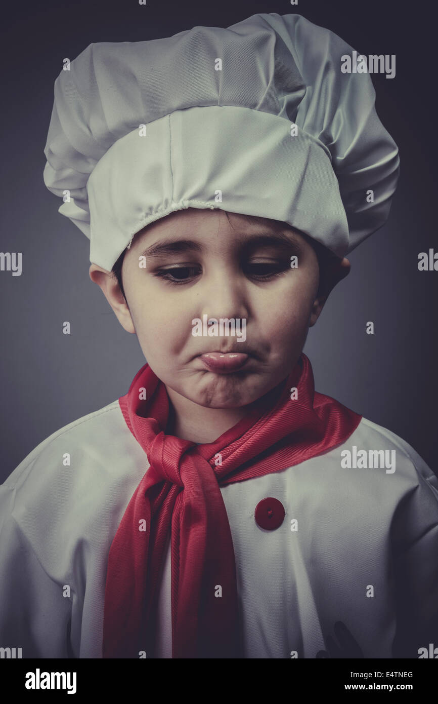 sad child dress funny chef, cooking utensils Stock Photo - Alamy