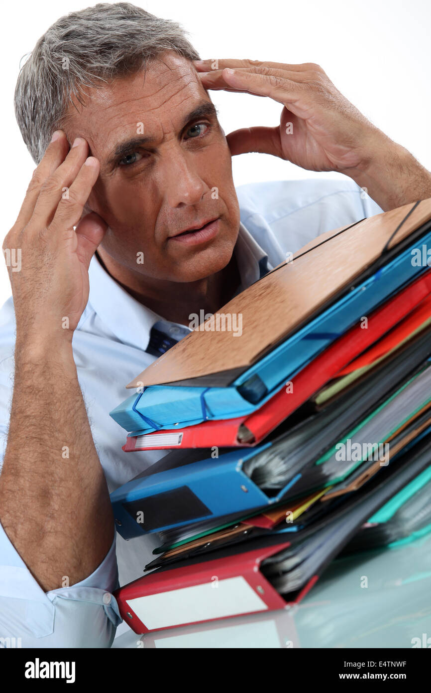 Man with stacks of paperwork Stock Photo - Alamy