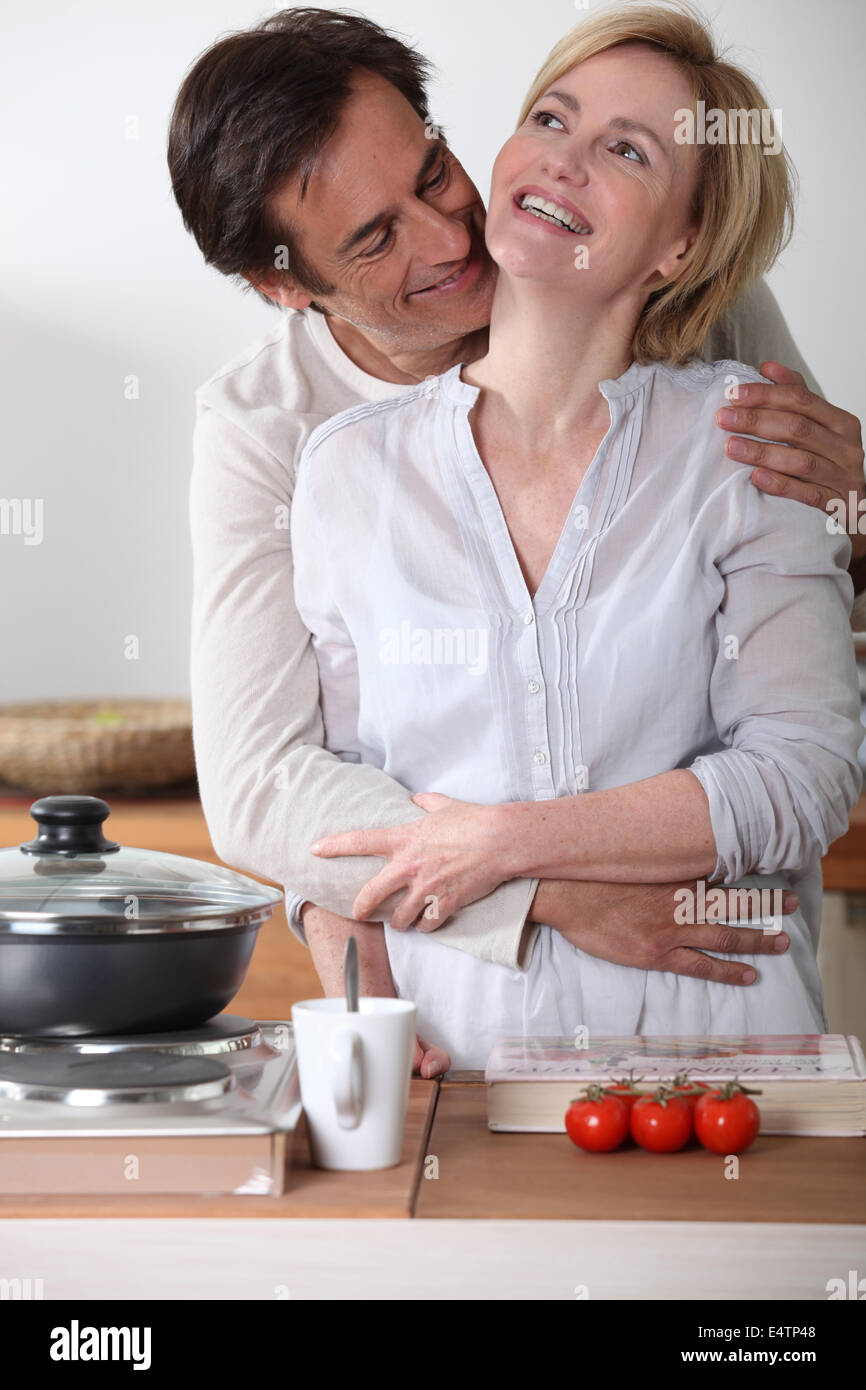 Happy couple cooking together at home Stock Photo - Alamy