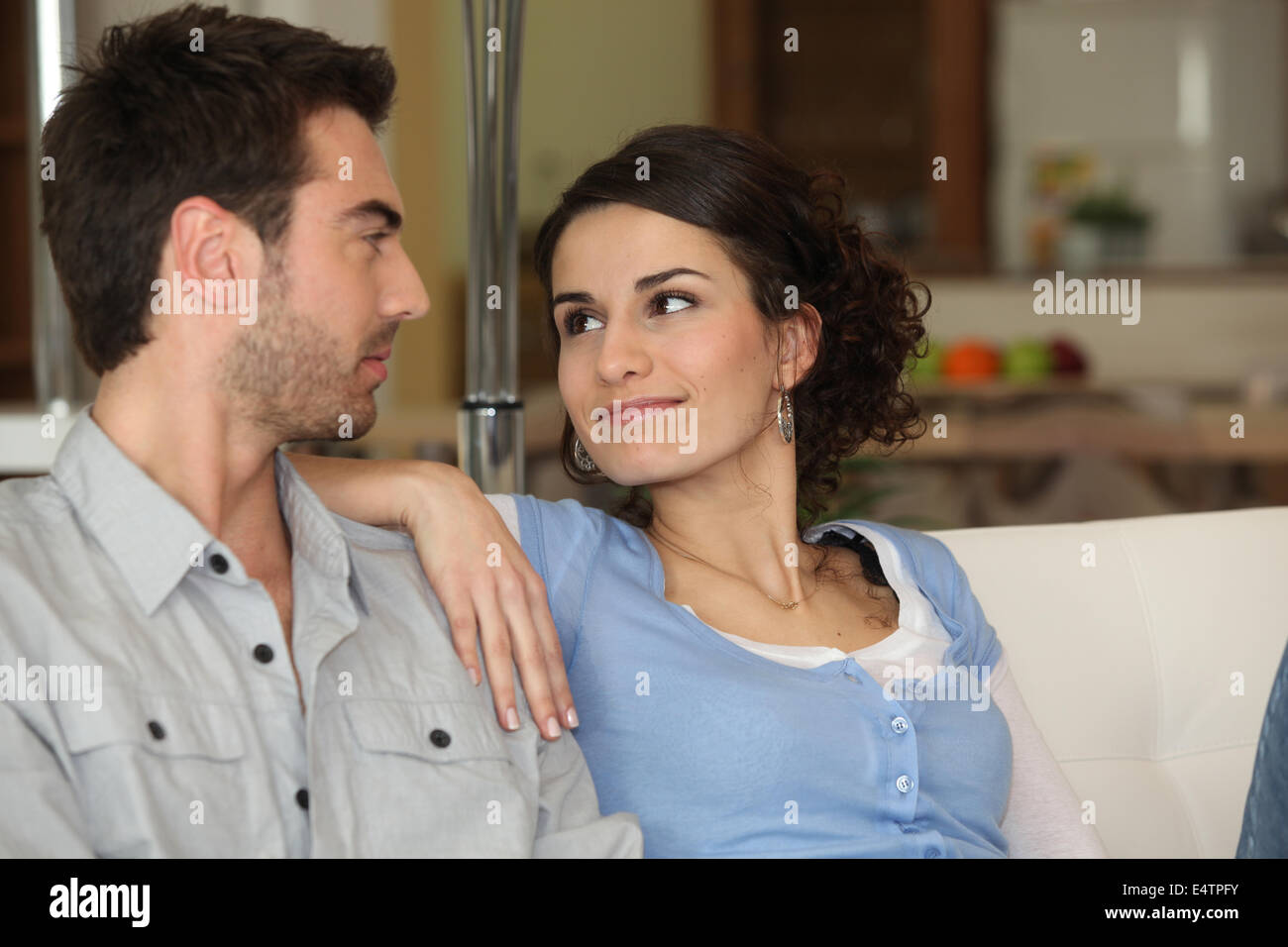 Couple on couch Stock Photo - Alamy