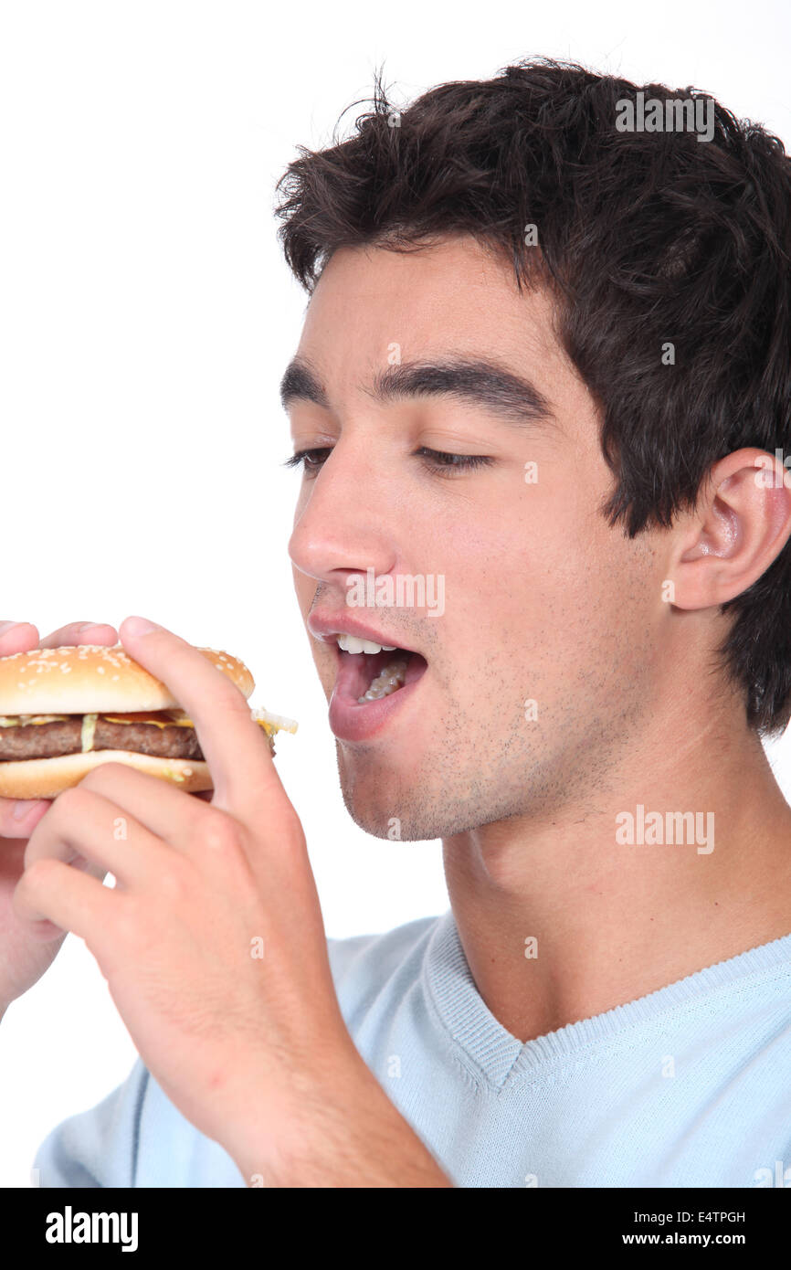 Boy eating hamburger Stock Photo - Alamy