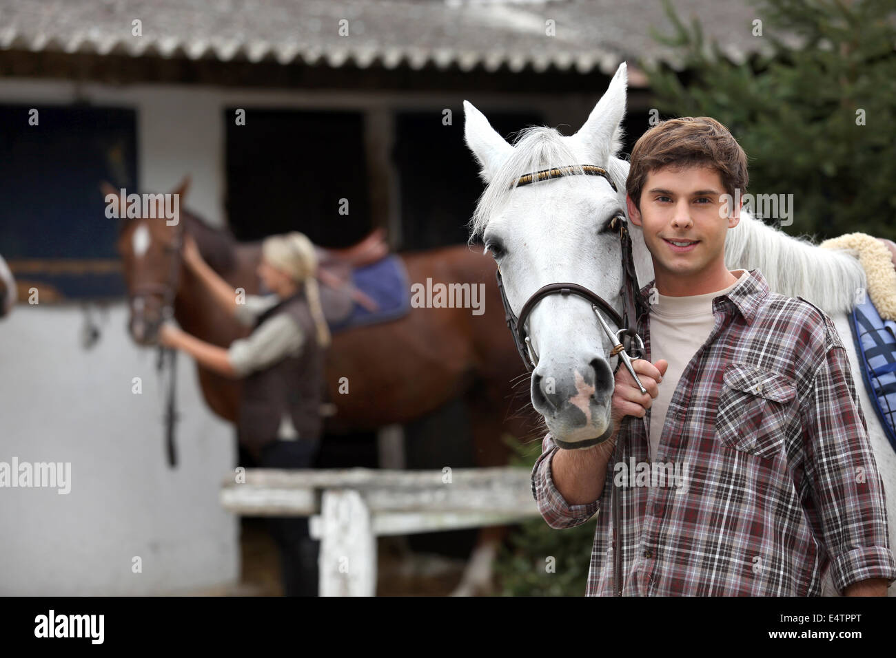 Man with horse in a stable Stock Photo - Alamy