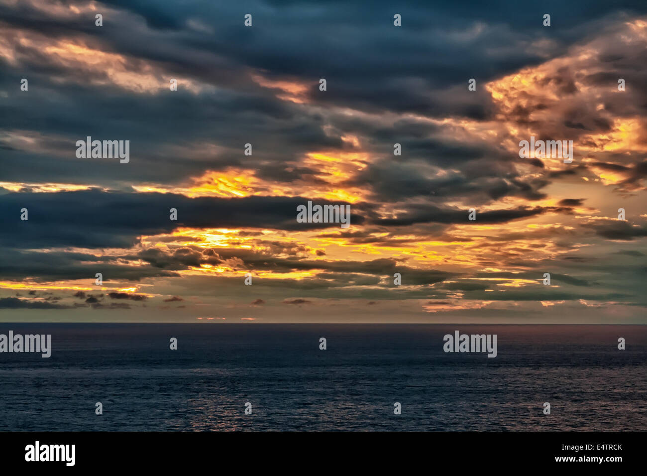 sunset on an overcast sea Stock Photo - Alamy