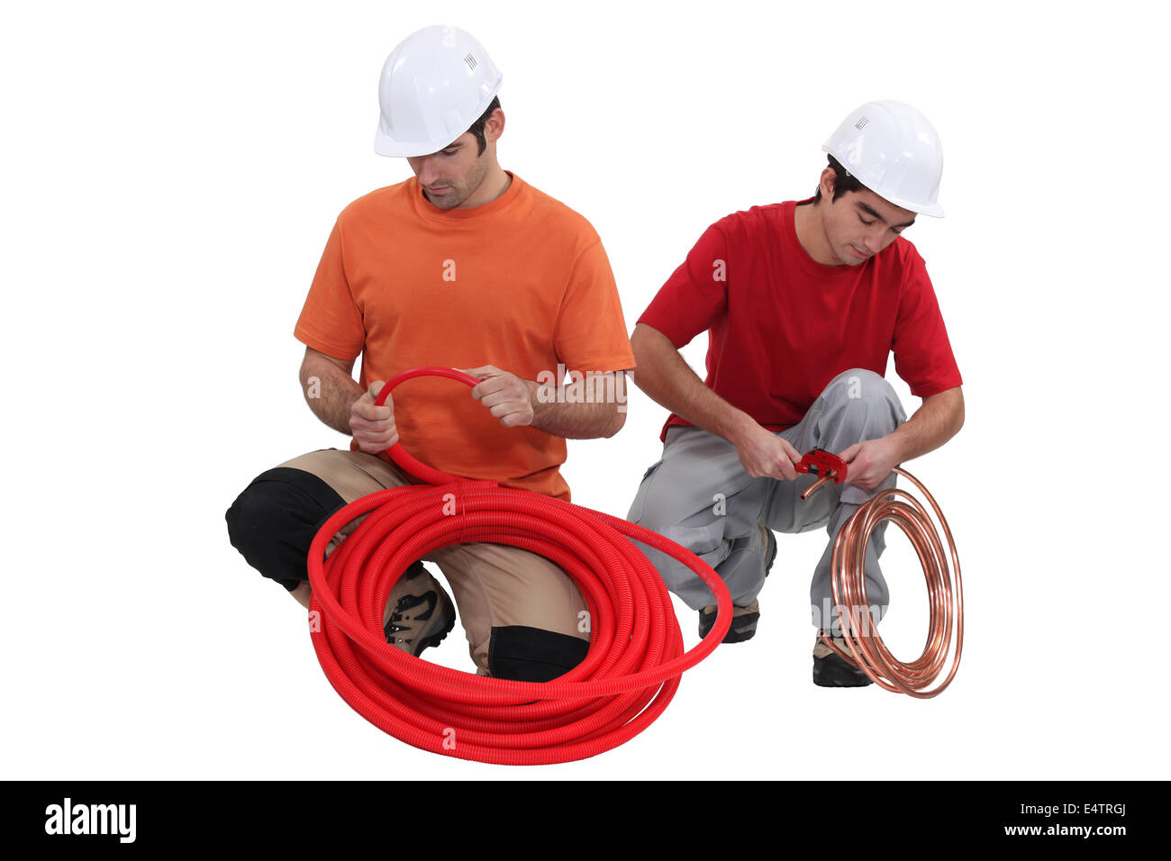 A team of tradesmen busy at work Stock Photo - Alamy