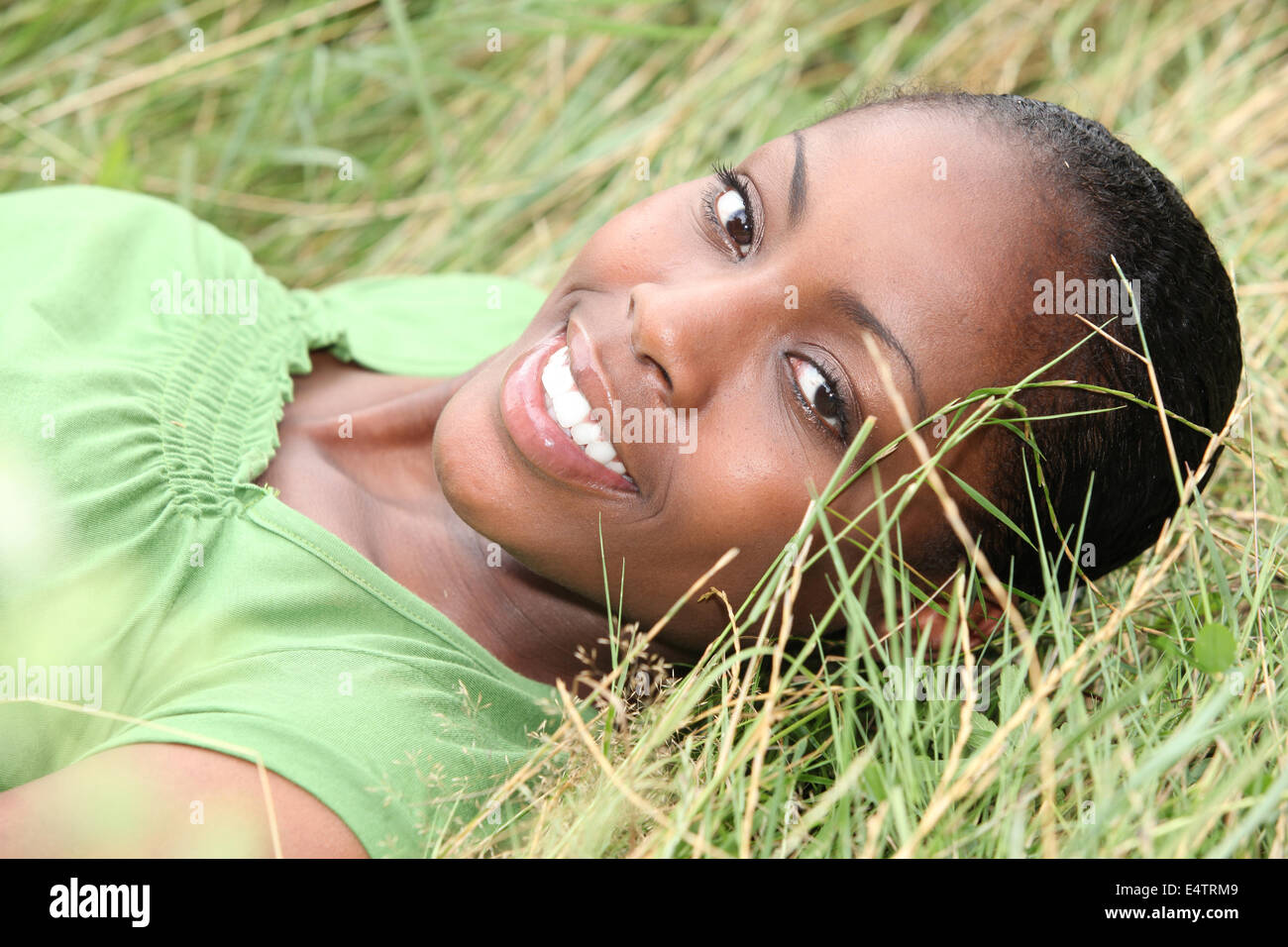 Woman laying in field Stock Photo - Alamy
