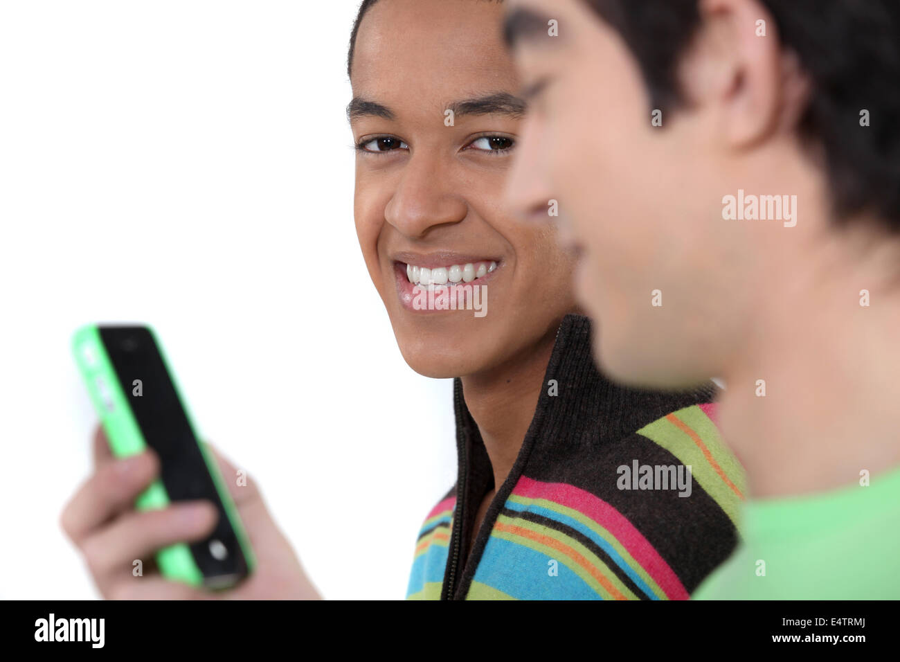 Two teenage boys reading text message Stock Photo - Alamy