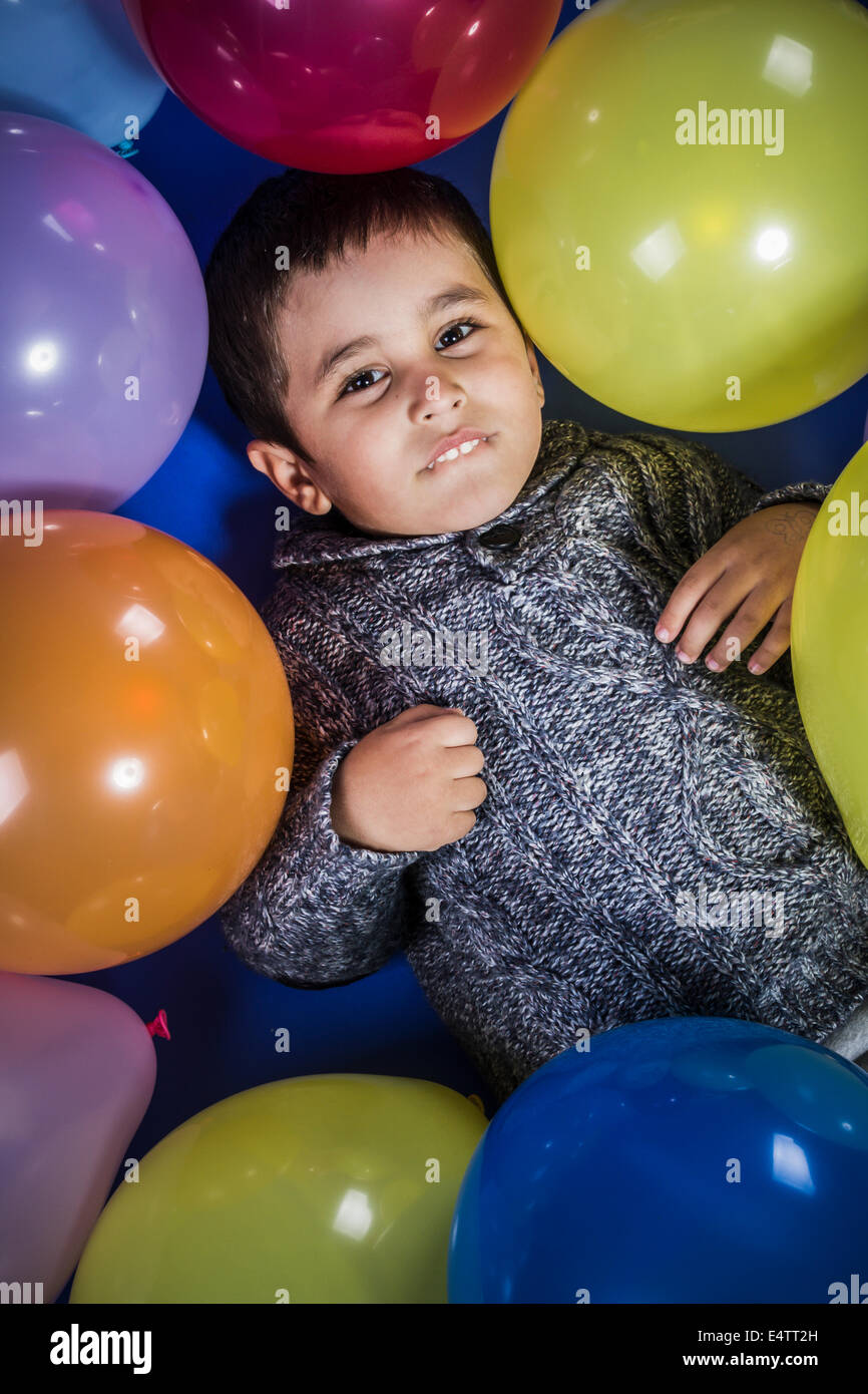 Decoration party, boy playing with balloons of many colors Stock Photo - Alamy