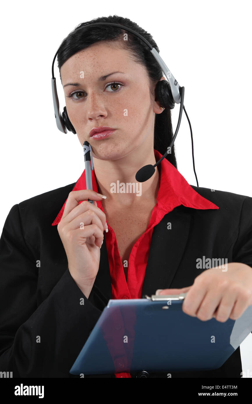 secretary wearing headset and thinking Stock Photo - Alamy