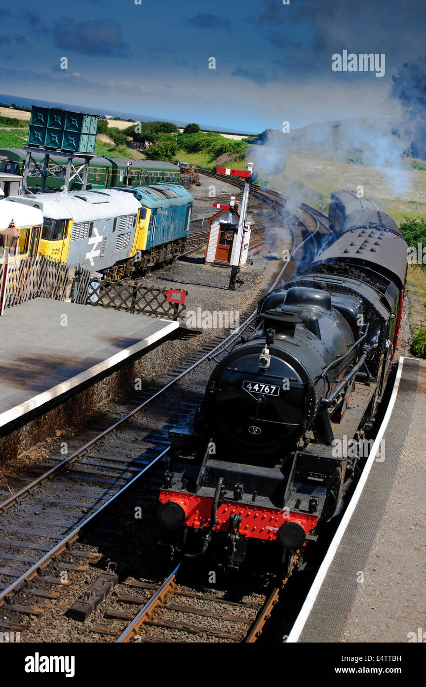 Steam train arriving on the Poppy line at Weybourne train station in ...