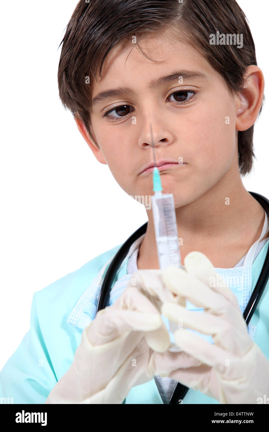 Little boy with syringe dressed as doctor Stock Photo - Alamy