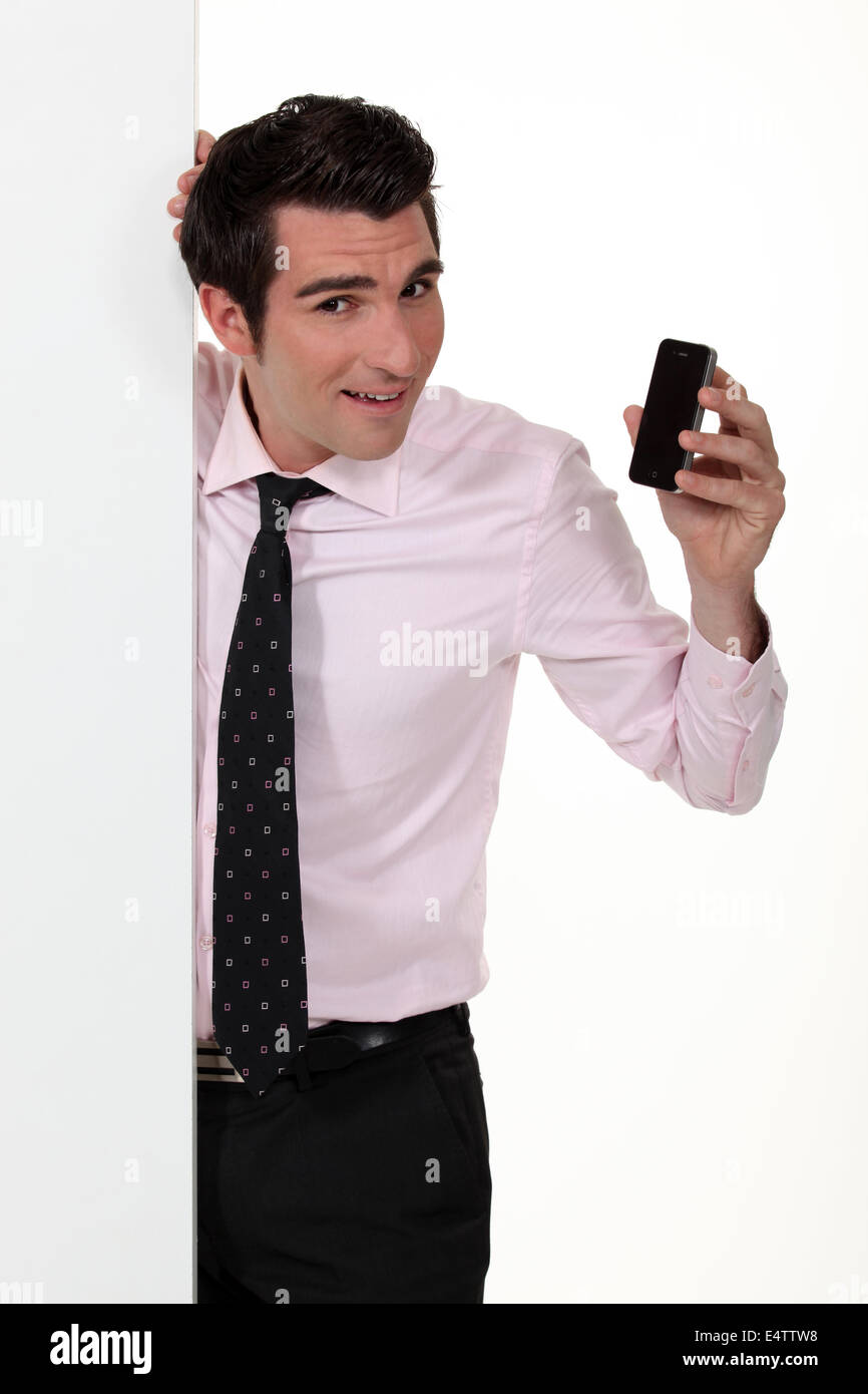 Salesman stood with poster and mobile Stock Photo - Alamy