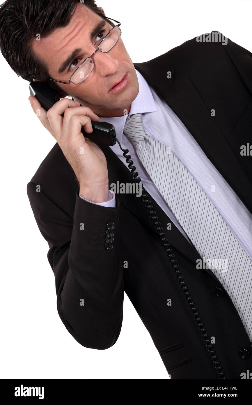 Concerned businessman talking on the phone Stock Photo - Alamy