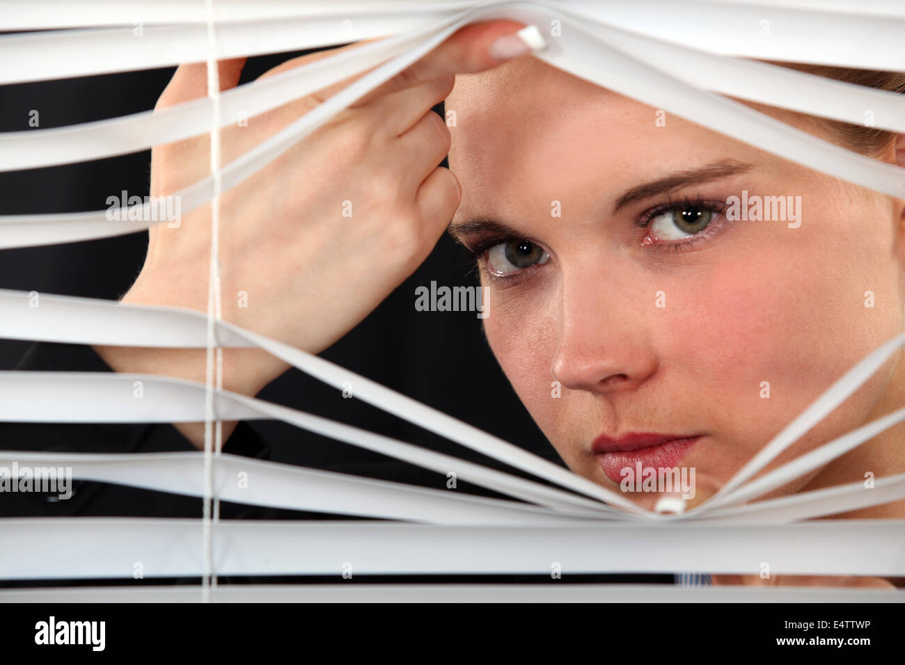 Woman looking through blinds Stock Photo - Alamy Woman looking through blinds Stock Photo - Alamy