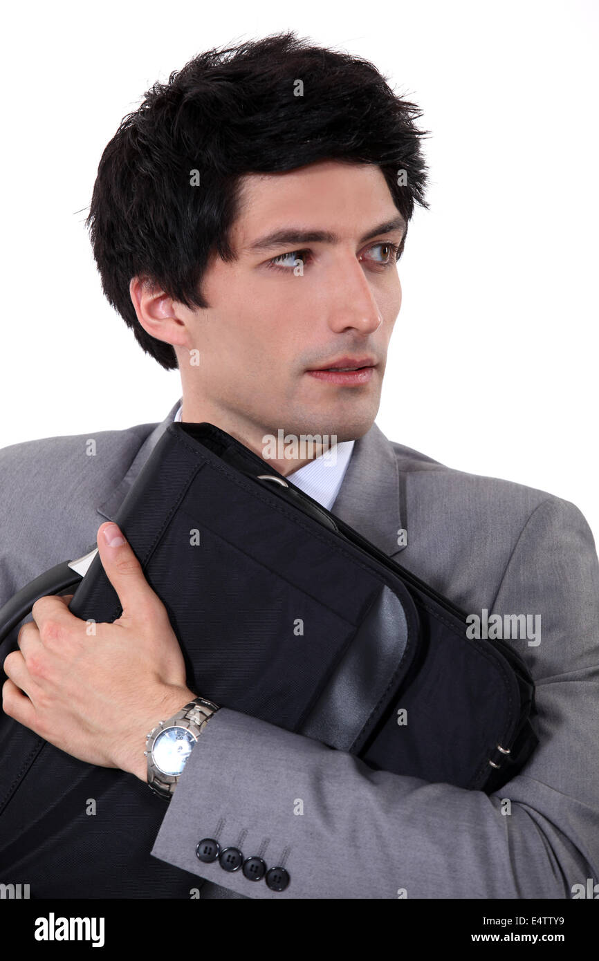businessman holding laptop in his arms Stock Photo - Alamy