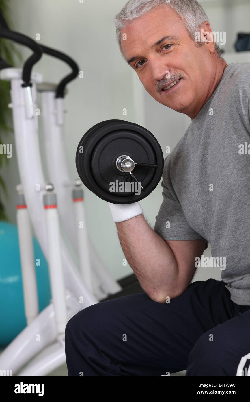 Man lifting a dumbbell Stock Photo - Alamy
