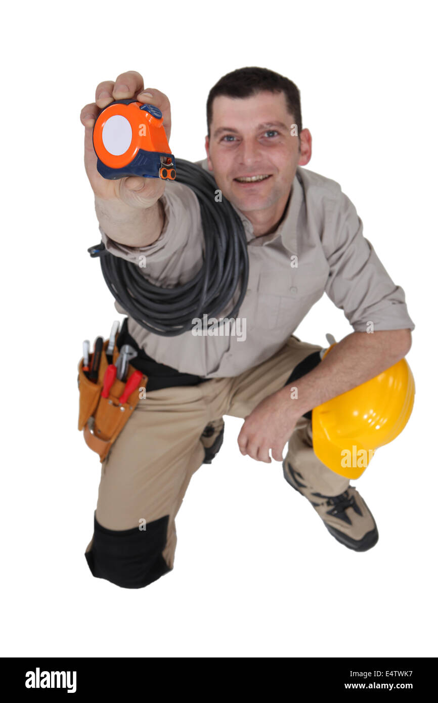Man holding up a measuring tape Stock Photo - Alamy