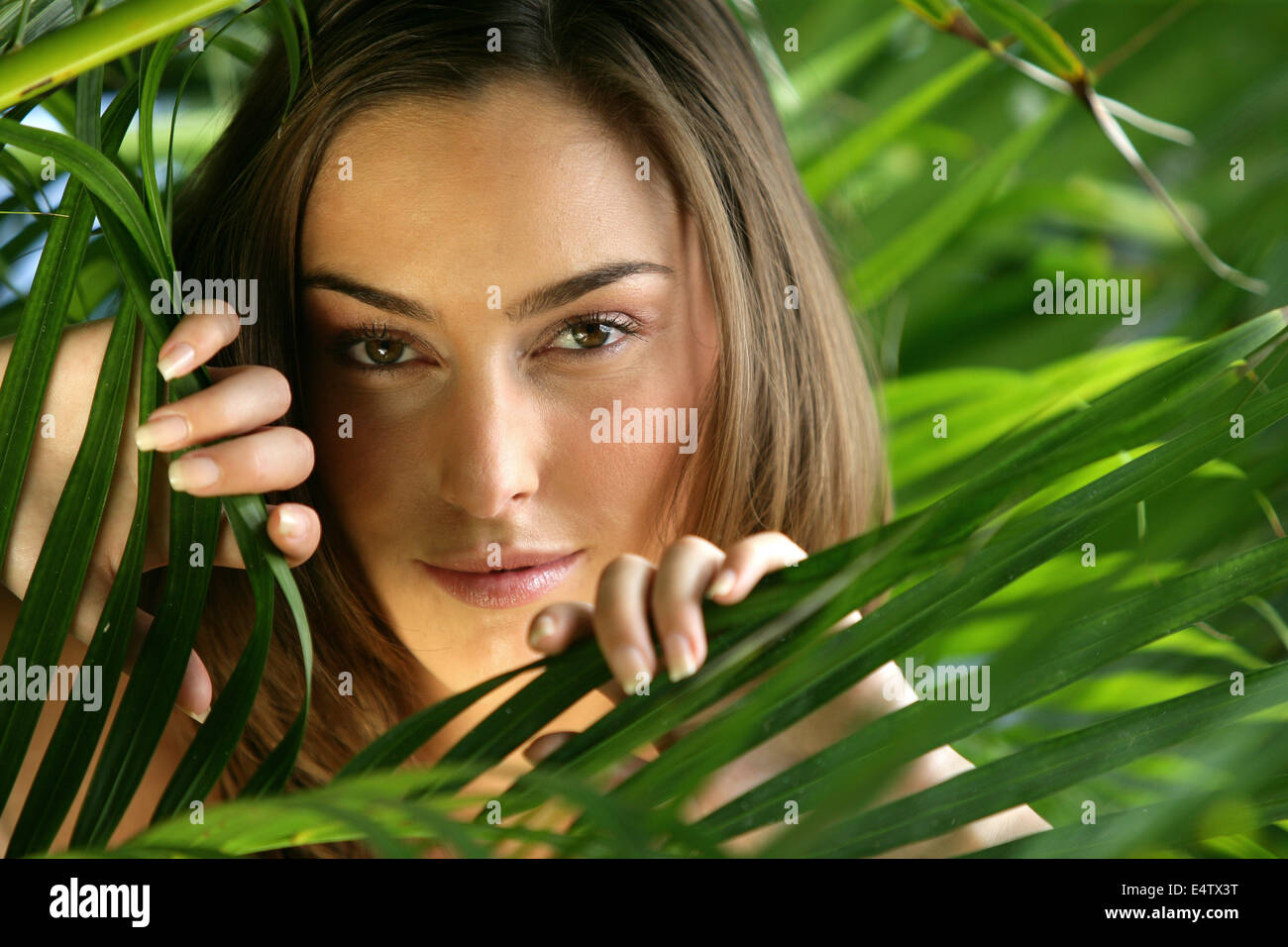 woman hiding behind a plant Stock Photo - Alamy